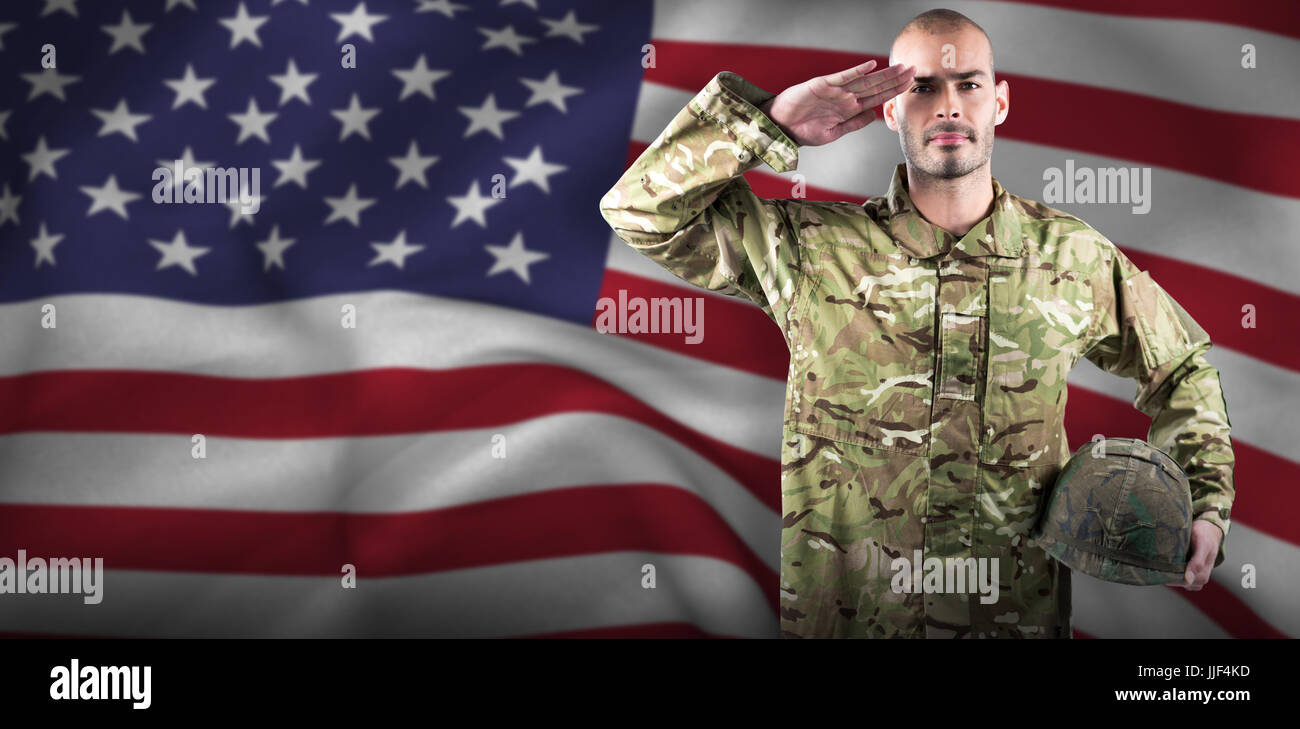 Portrait of confident soldier holding helmet while saluting against ...