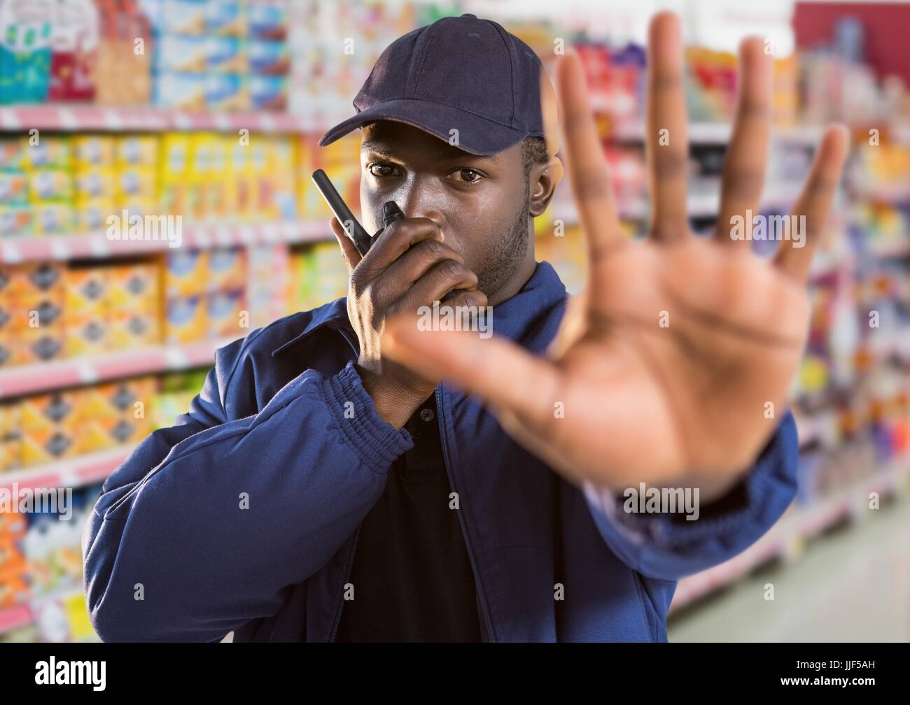 Digital composite of security guard of the supermarket saying stop with ...