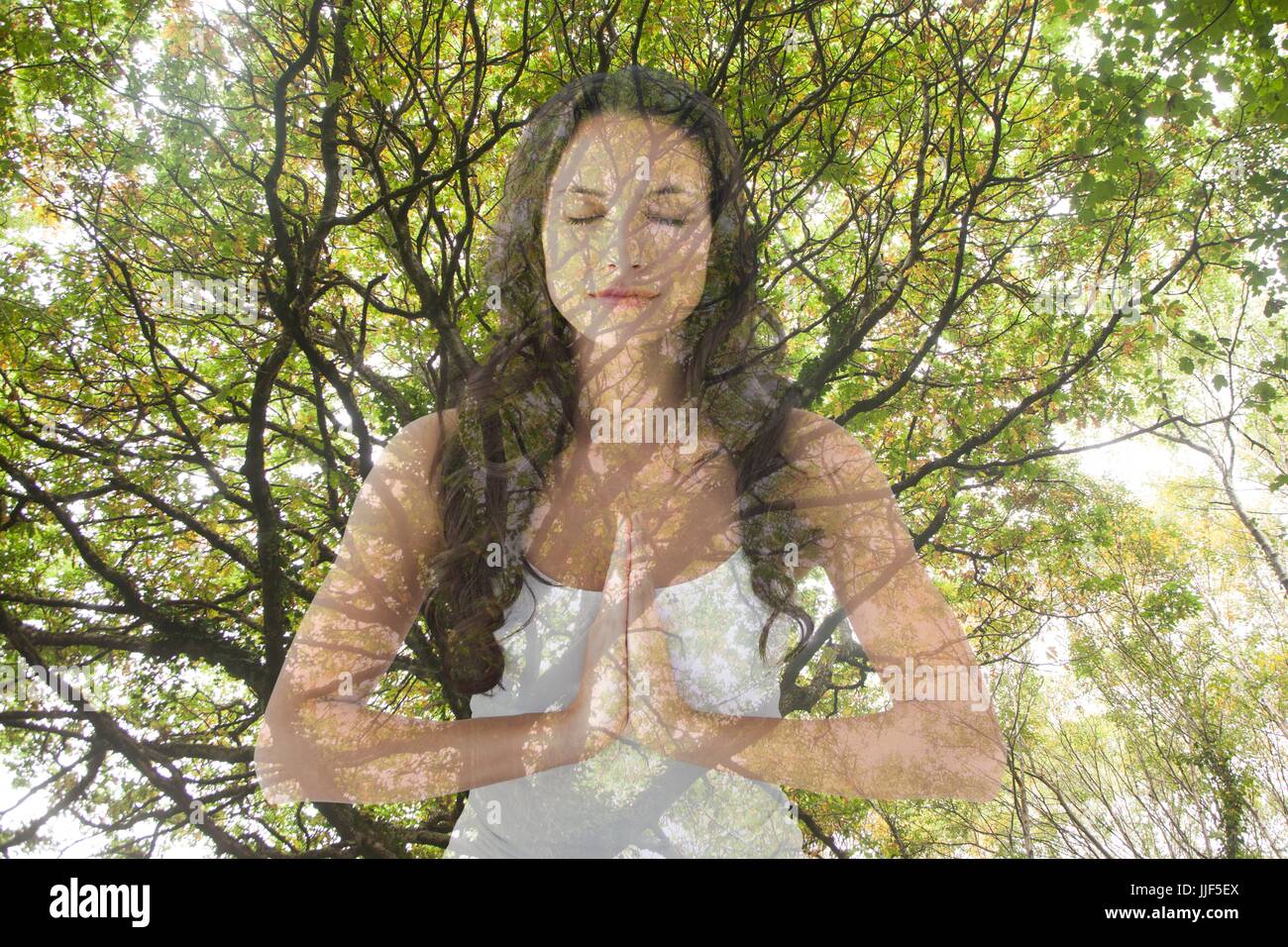 Digital composite of Woman doing yoga under a tree Stock Photo - Alamy
