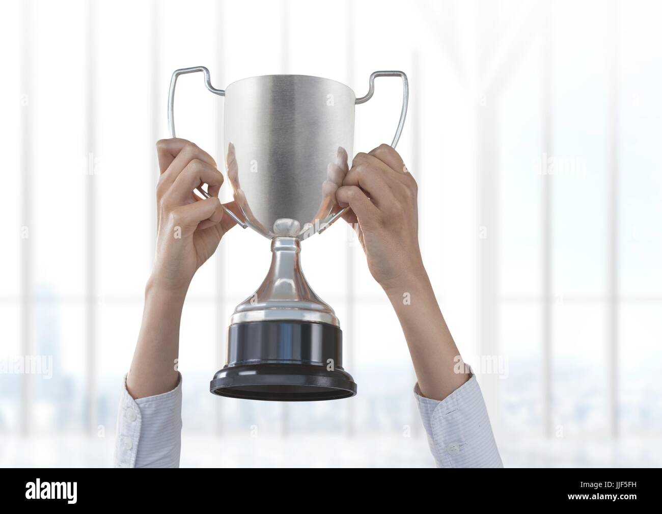 Digital composite of Business hand holding trophy against window Stock ...