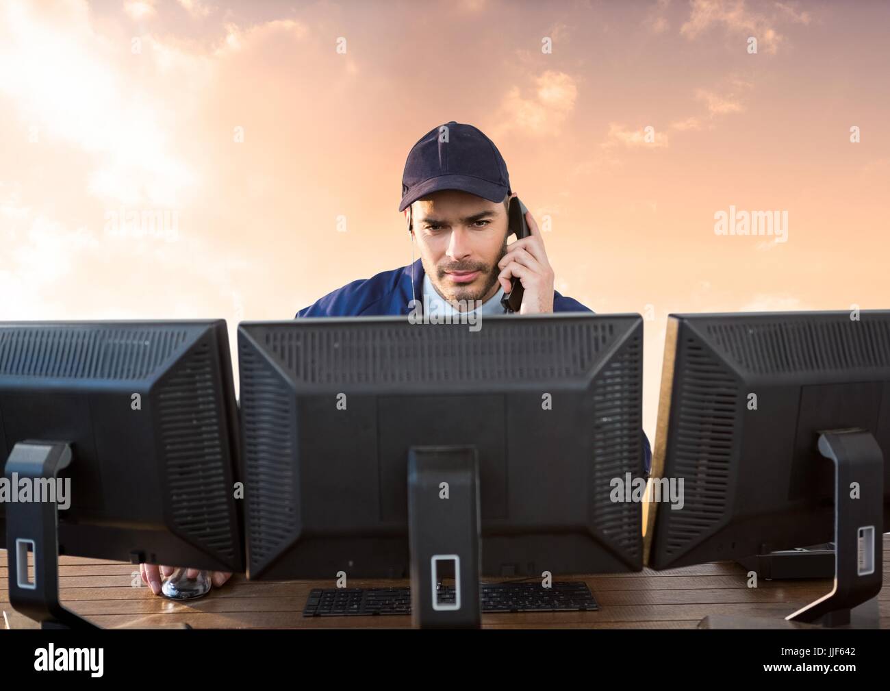 Digital composite of Security man on computers with cloudy sky Stock ...
