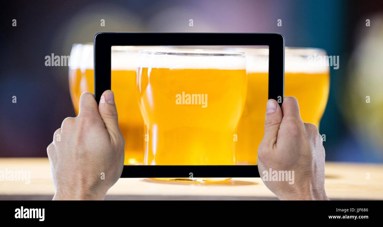 Digital composite of Cropped hands photographing beer glasses through ...
