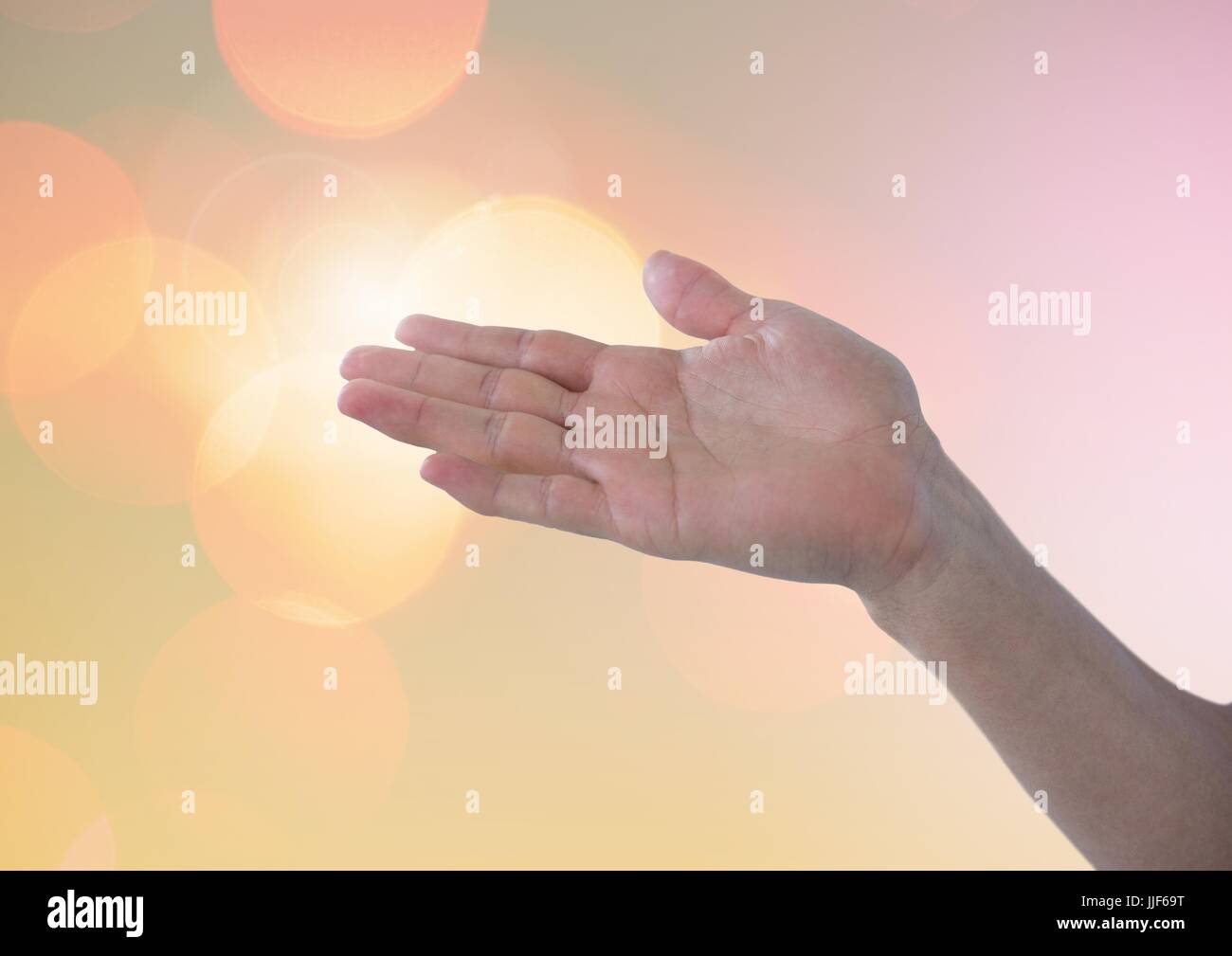 Digital composite of Hand posture with sparkling light bokeh background ...
