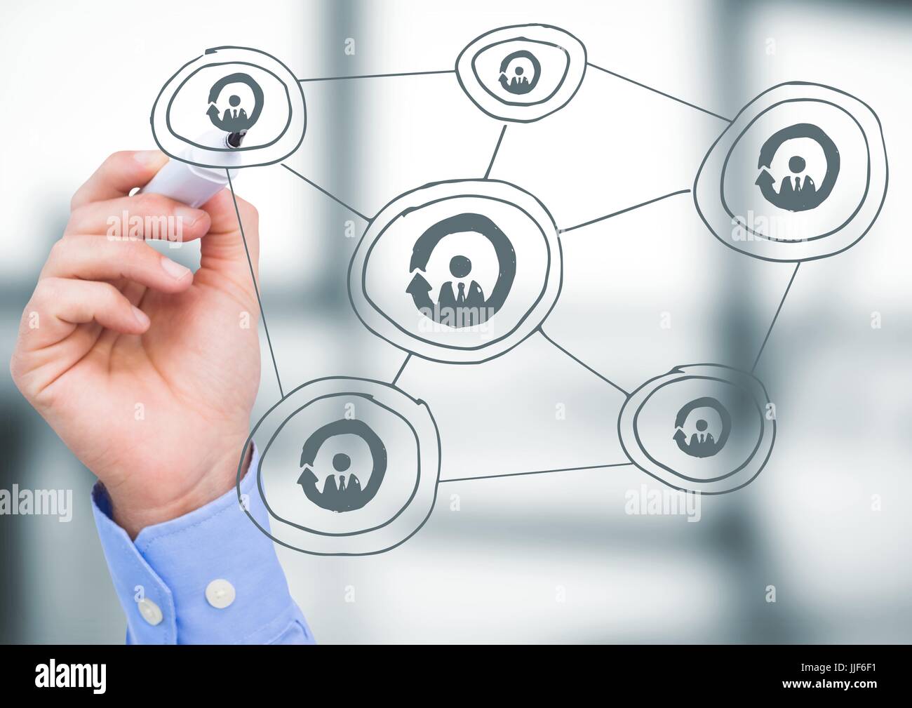 Digital composite of Hand writing network doodle against blurry grey ...