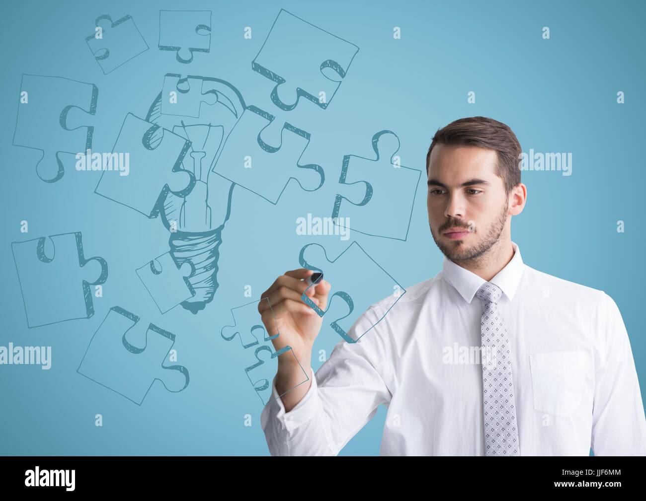 Digital composite of Business man drawing jigsaw doodle against blue ...