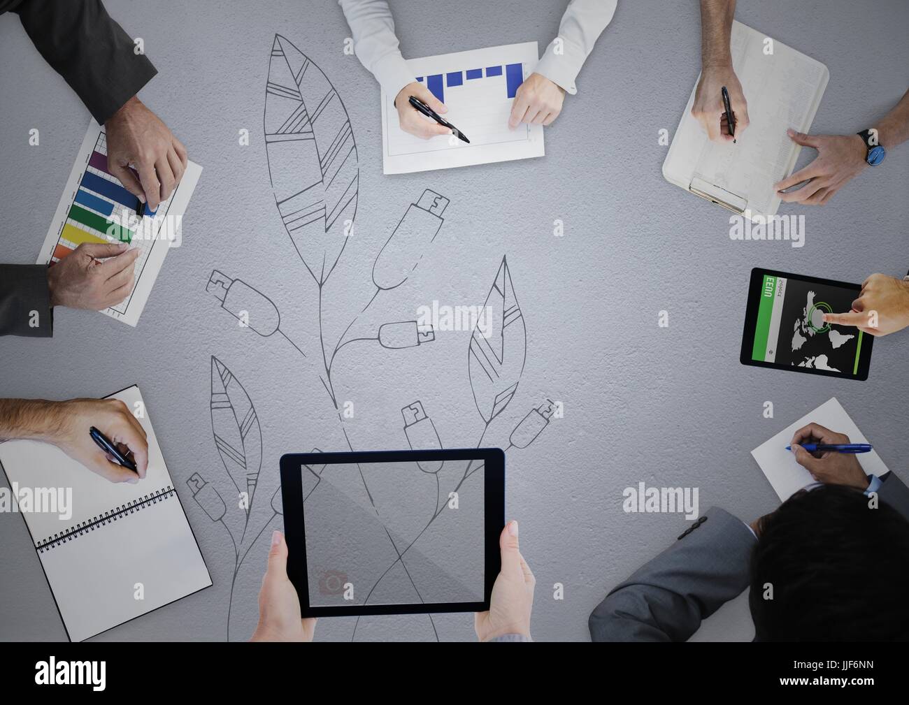 Digital composite of Overhead of business team writing on grey surface ...