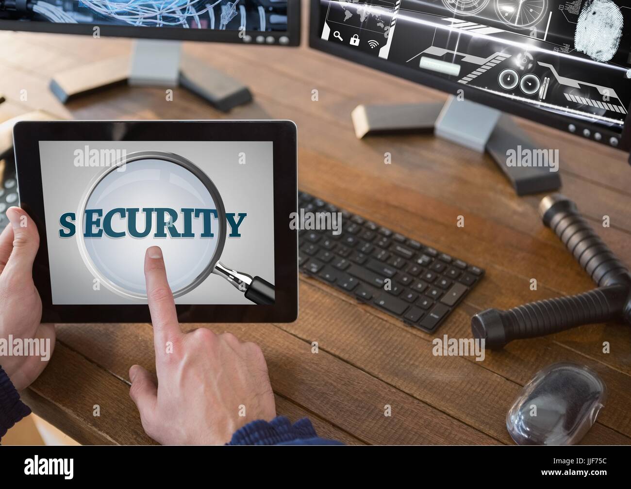 Digital composite of security guard using technology with a laptop ...