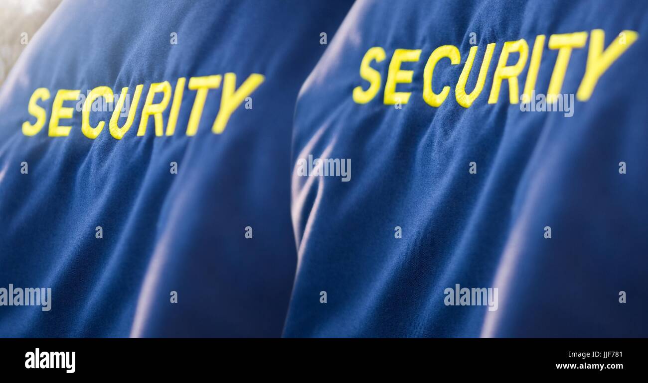 Digital composite of Security men jackets side by side outside Stock ...