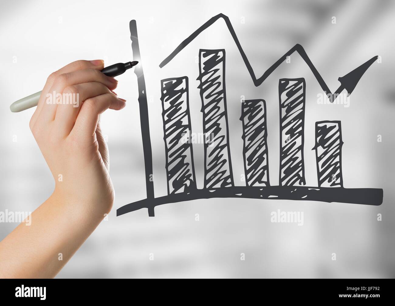 Digital composite of Hand drawing graph doodle against blurry grey ...