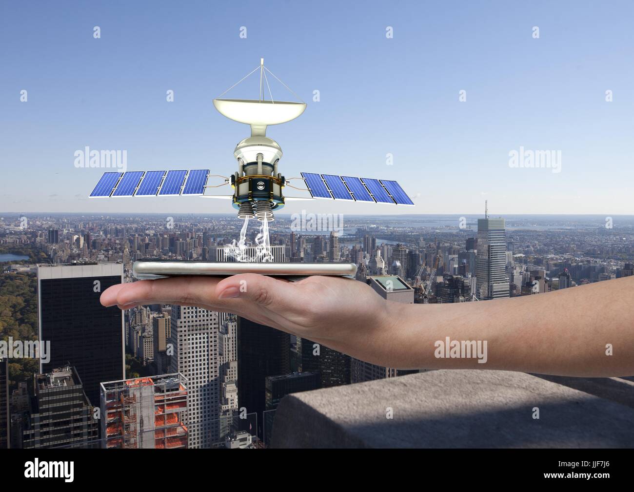 Digital composite of solar panel satellite on hand with city behind ...