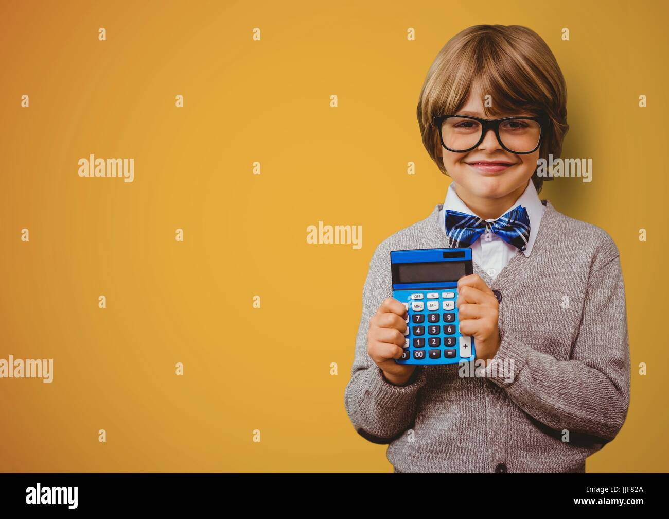Digital composite of Boy smiling with calculator against yellow ...