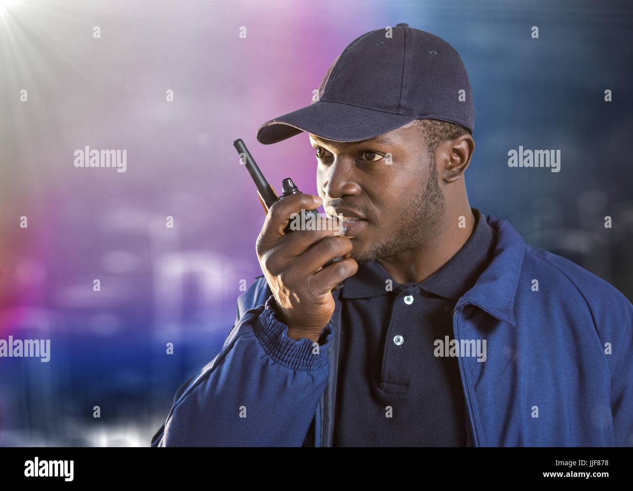 Digital composite of Security guard with walkie talkie against blurry ...