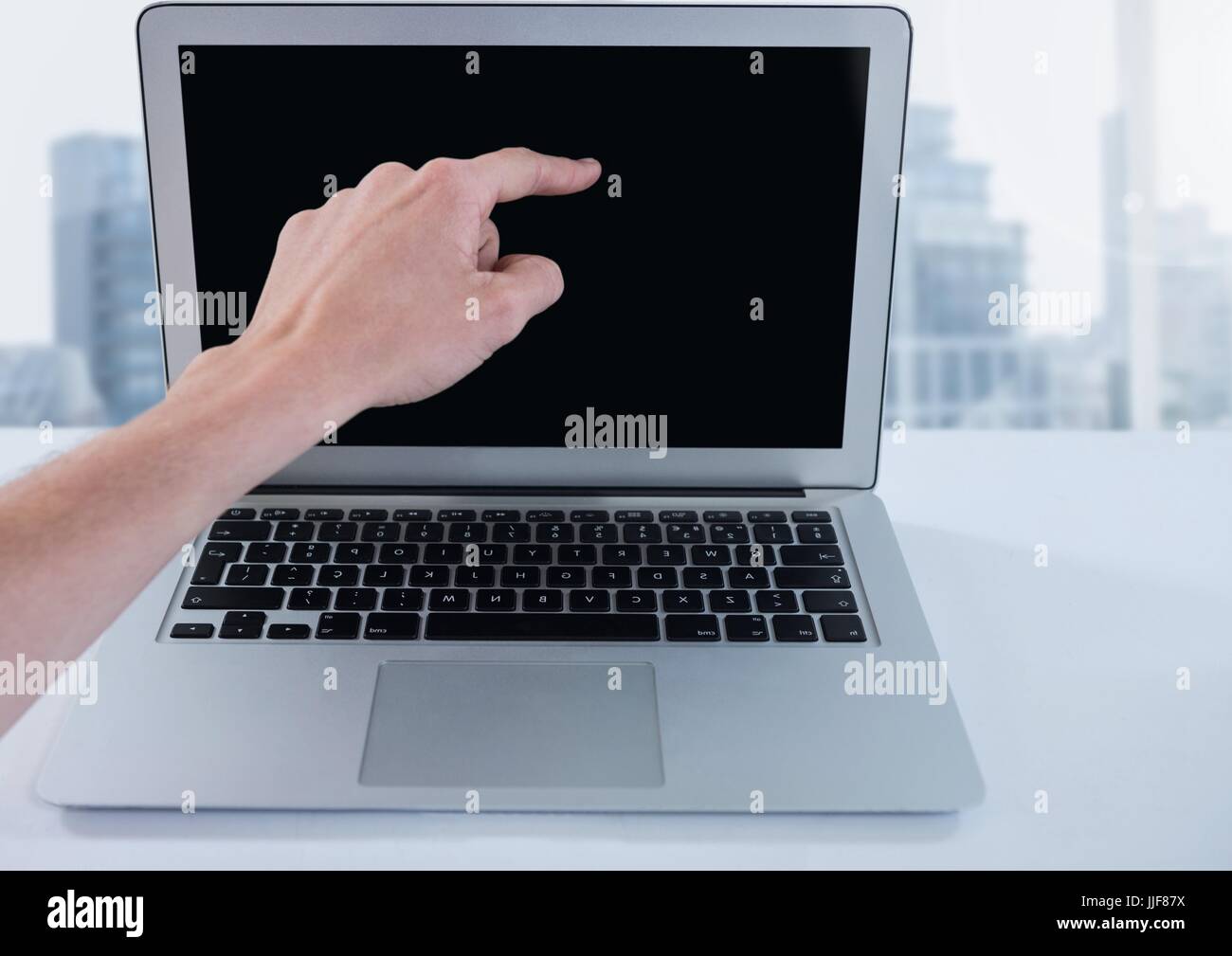 Digital composite of Businessman touching laptop by window Stock Photo ...