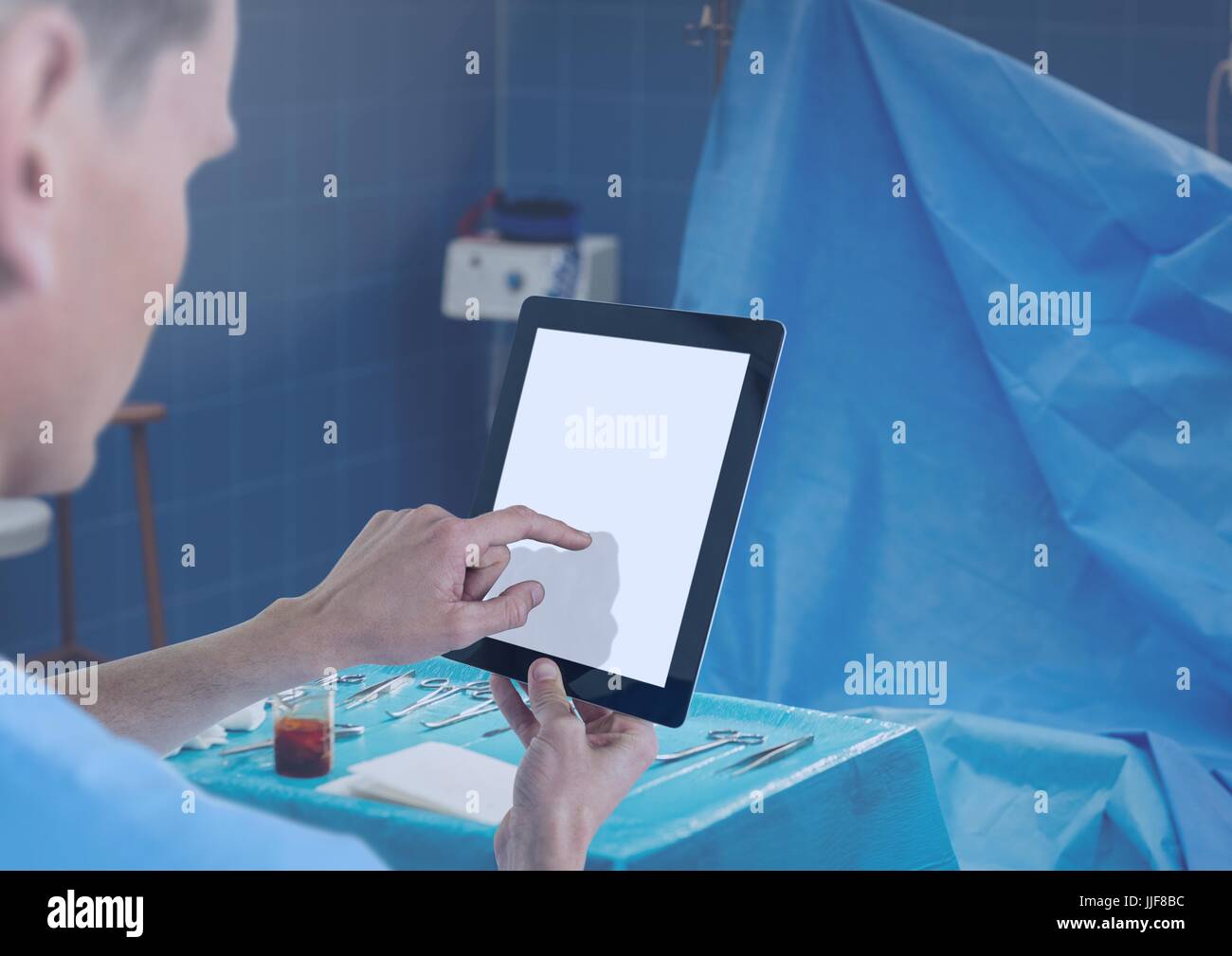 Digital composite of Doctor holding tablet in surgery room Stock Photo ...