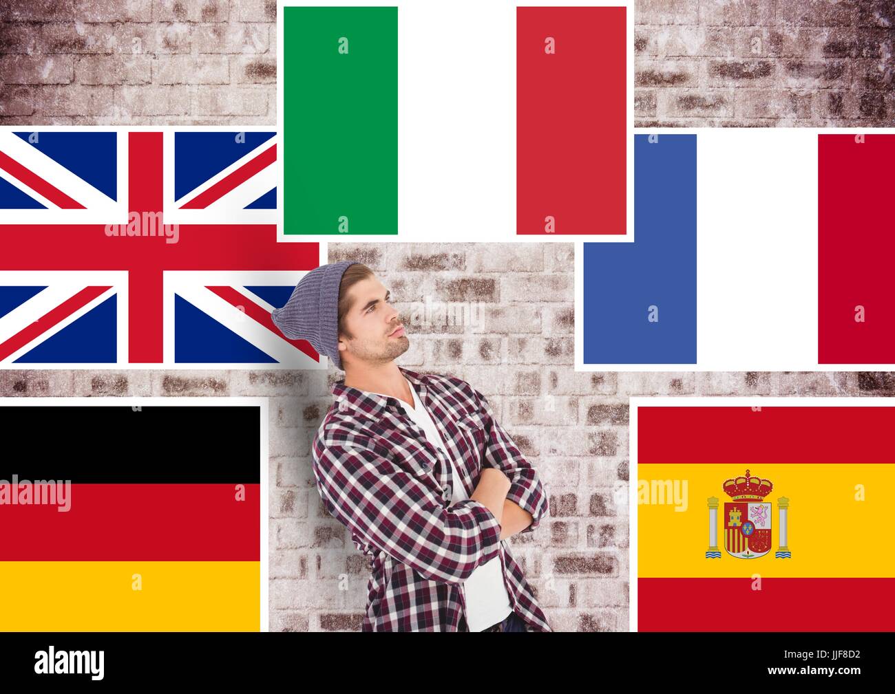Digital composite of main language flags around young man. Brick wall ...