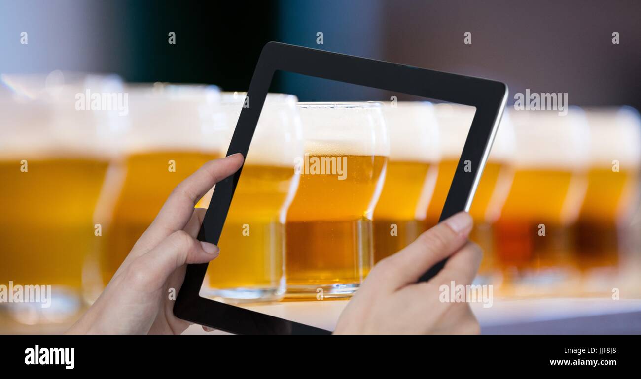 Digital composite of Hands photographing beer glasses through digital ...