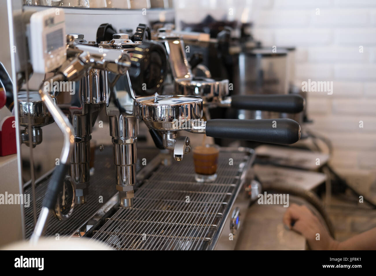 Professional coffee maker machine brewing and pouring fresh espresso ...