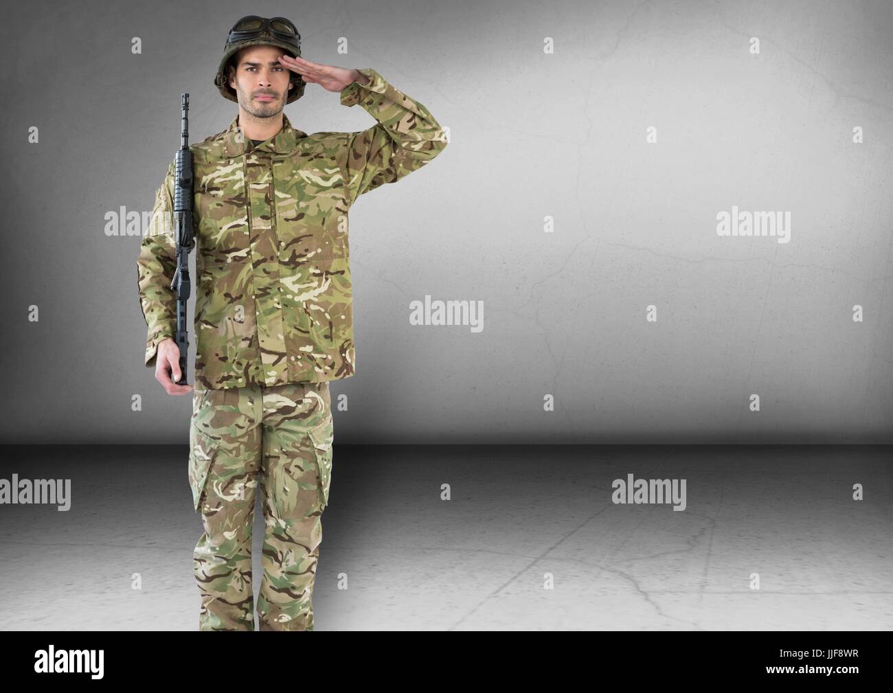 Digital composite of soldier saluting and with weapon. Concrete room ...