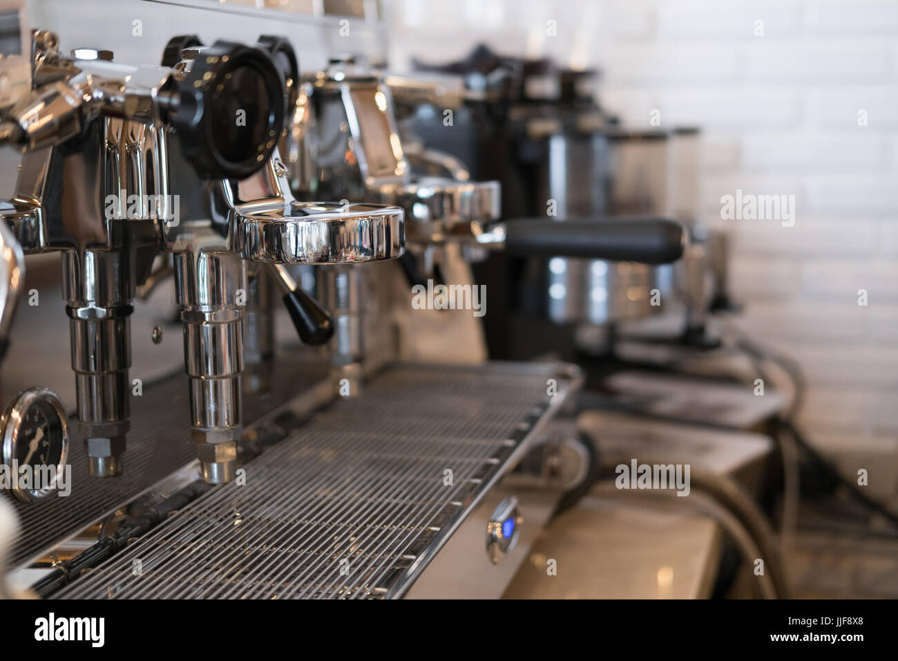 Professional coffee maker machine brewing fresh espresso coffee in cafe ...