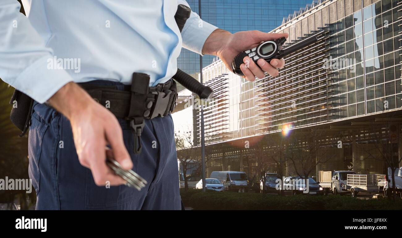 Digital composite of Mid section of security guard holding keys and ...