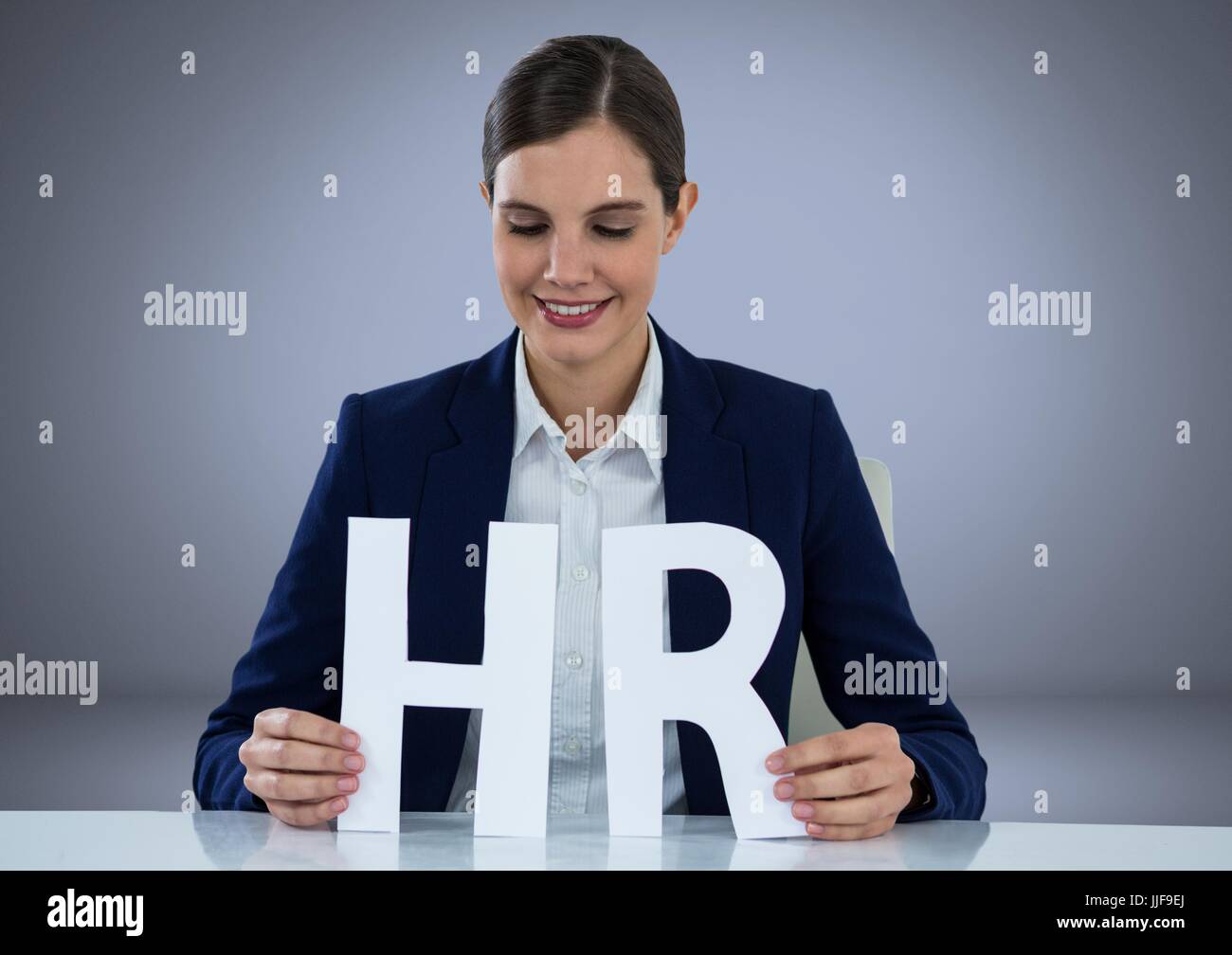 Digital composite of Cut out HR letters in models hands Stock Photo - Alamy