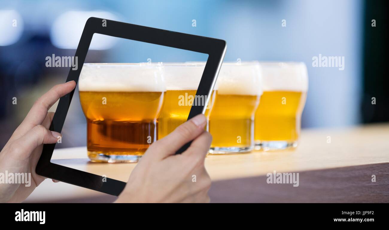 Digital composite of Hand taking picture of beer glasses with digital ...