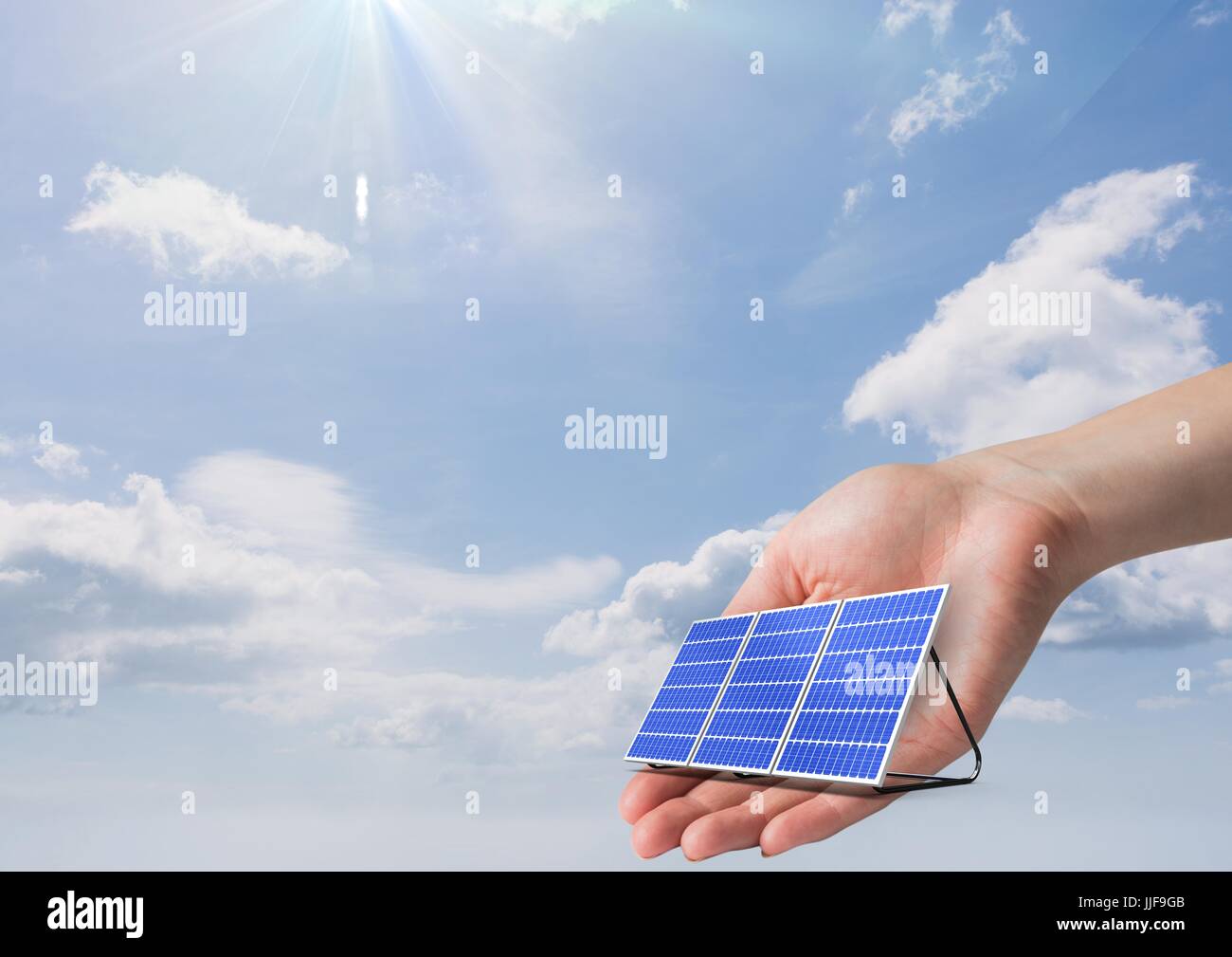 Digital composite of Digital image of solar panel on hand against sky ...