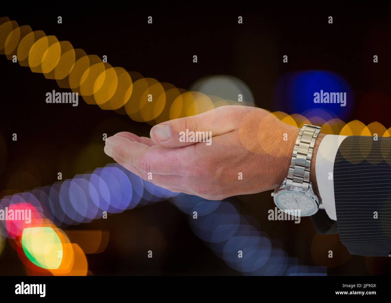 Digital composite of Businessman Hand with rich watch with sparkling ...