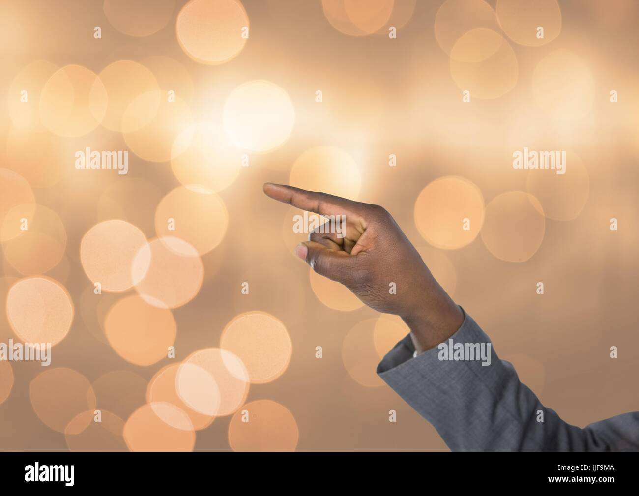 Digital composite of Hand pointing angular with sparkling light bokeh ...
