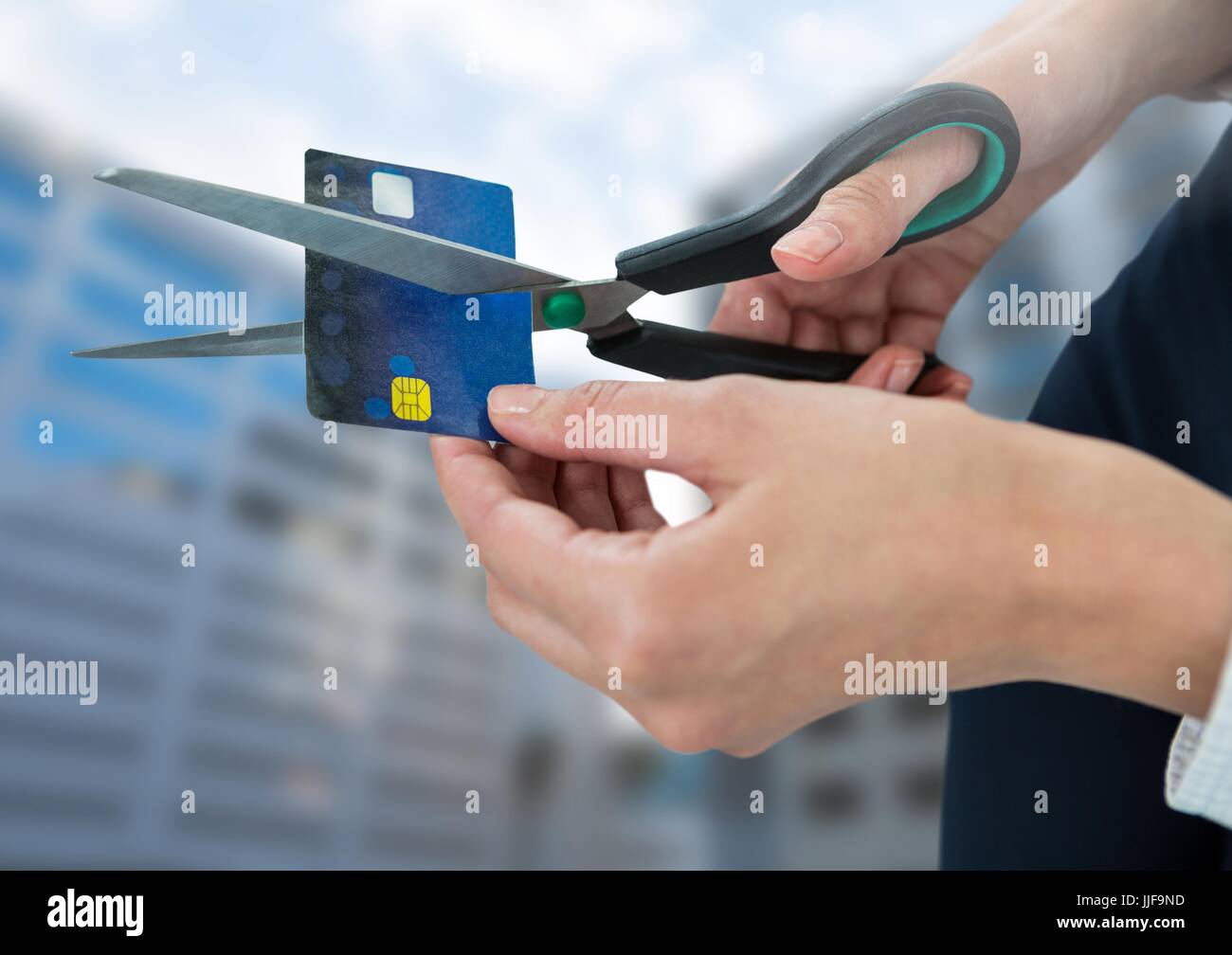 Digital composite of Hands cutting bank card with buildings Stock Photo ...