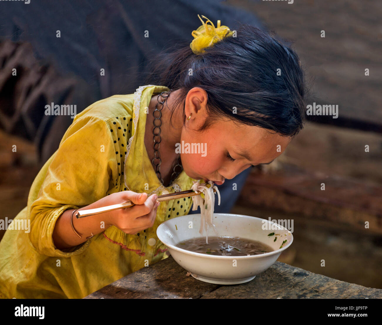 Vietnamese Hmong girls eating noddle in Cau Cau market Northern Vietnam ...