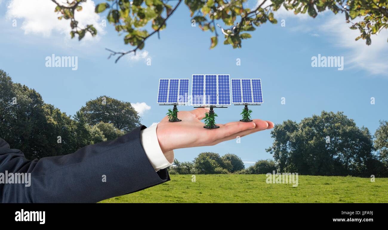 Digital composite of solar panels on hand in field Stock Photo - Alamy