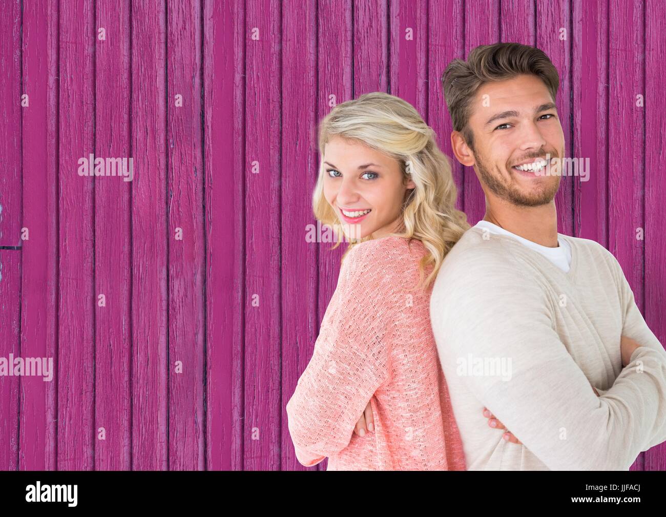 Digital composite of couple back with back, smiling with pink wood ...
