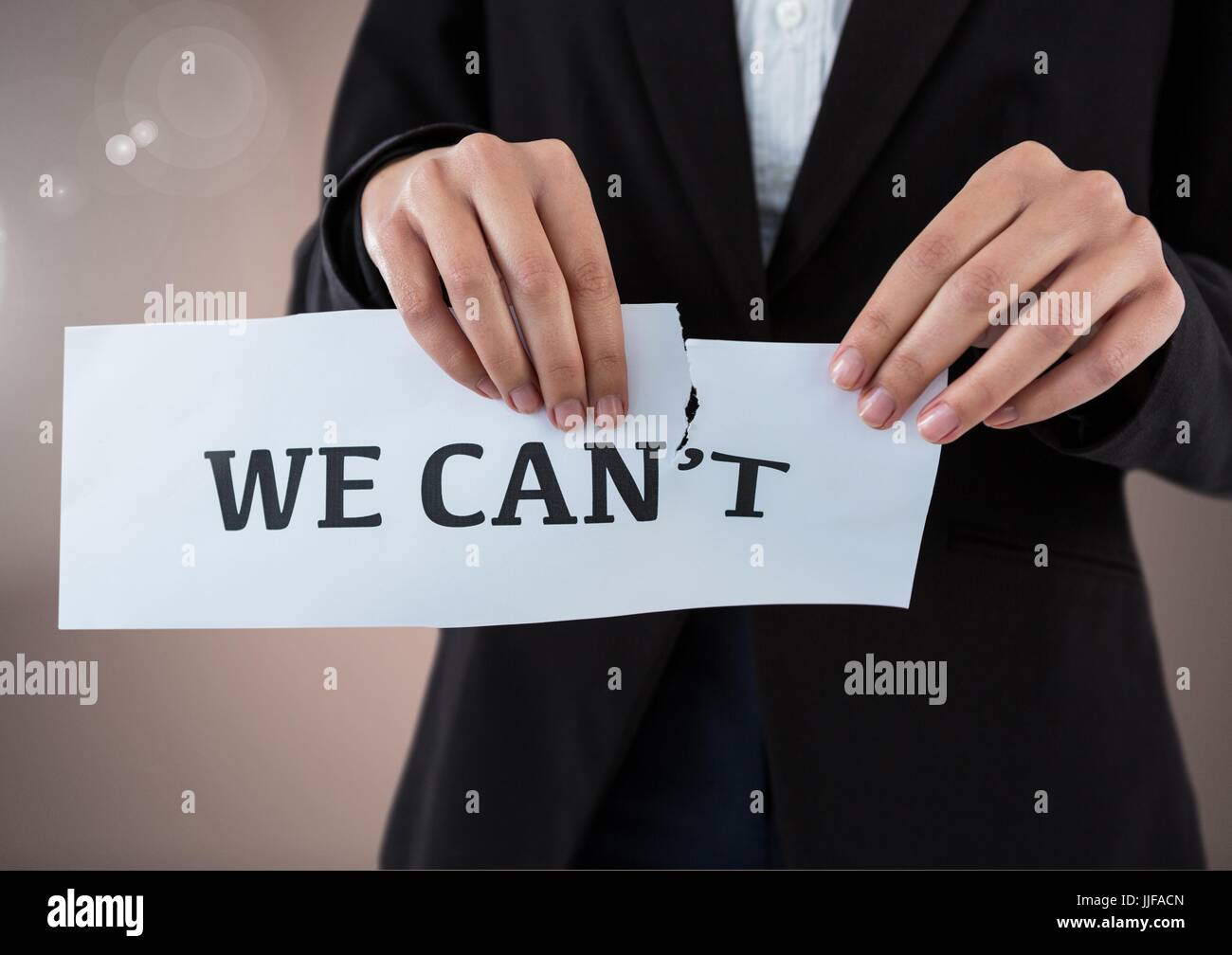 Digital composite of Hands ripping We Can't text on paper Stock Photo ...