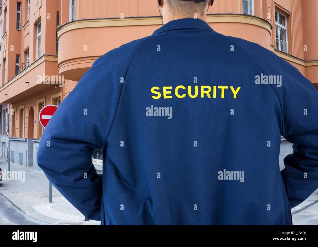 Digital composite of Rear view of security guard standing in city Stock ...