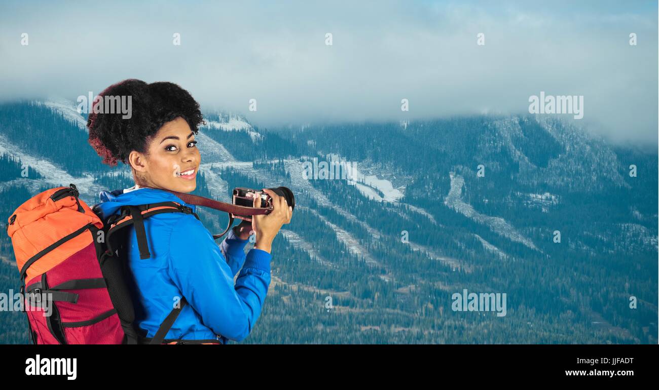 Digital composite of Portrait of smiling hiker with camera standing ...