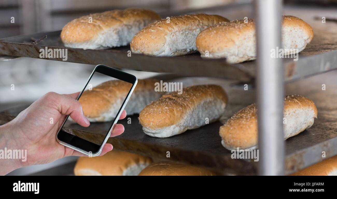 Digital composite of Hand taking picture of breads through smart phone ...
