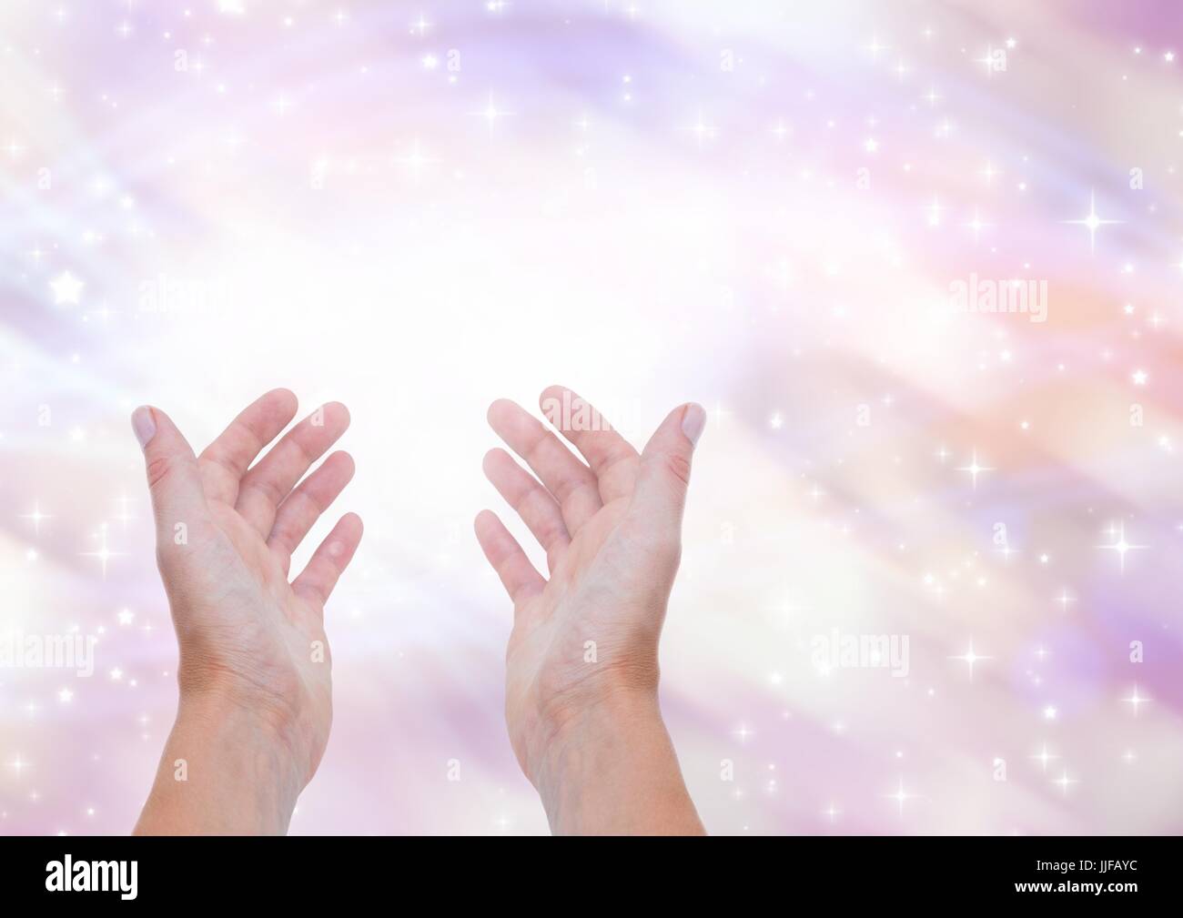Digital composite of Hands holding invisible space with sparkling light ...