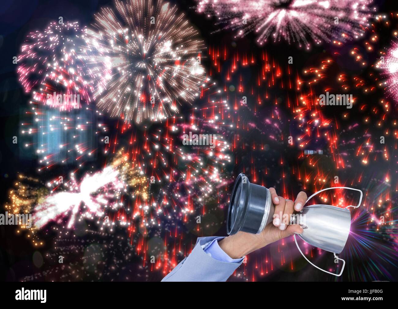 Digital composite of business hand with trophy. Red fireworks Stock ...