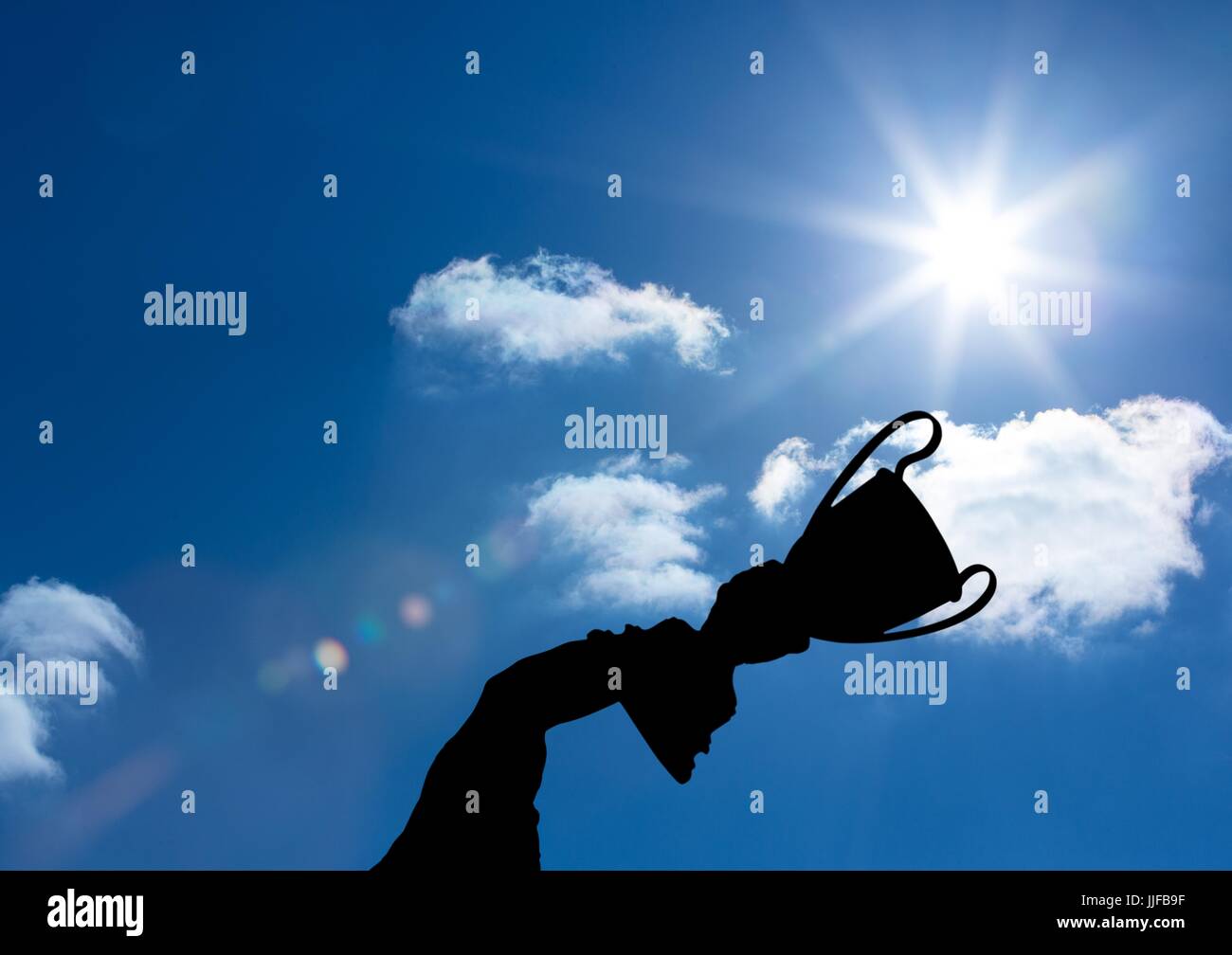 Digital composite of business hand with trophy shade in the sky Stock ...