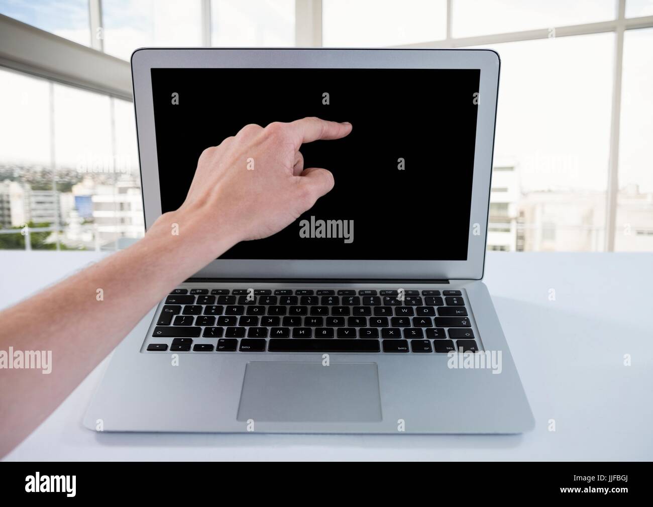 Digital composite of Hand pointing at laptop with windows Stock Photo ...