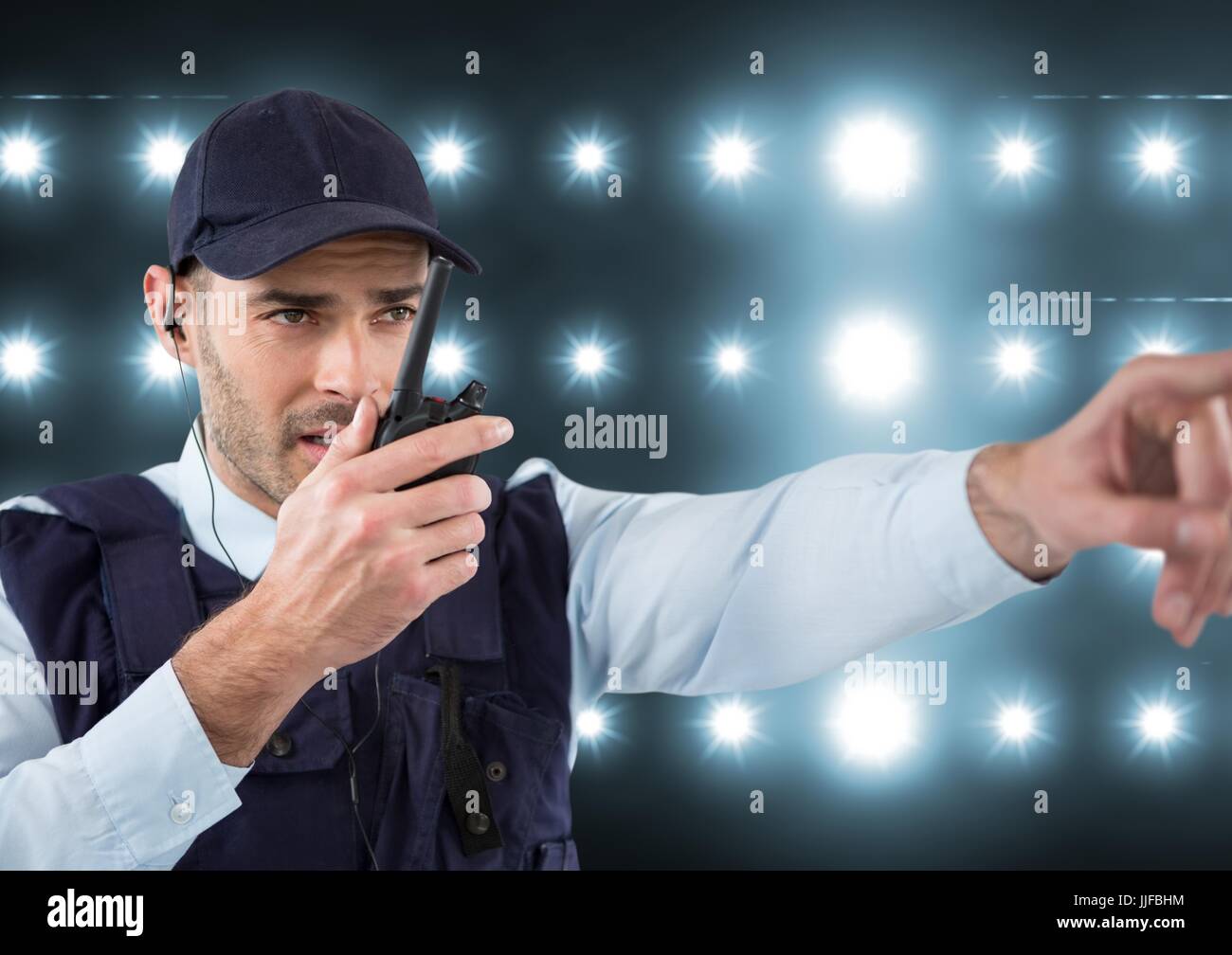 Digital composite of Security guard speaking with walkie-talkie and ...