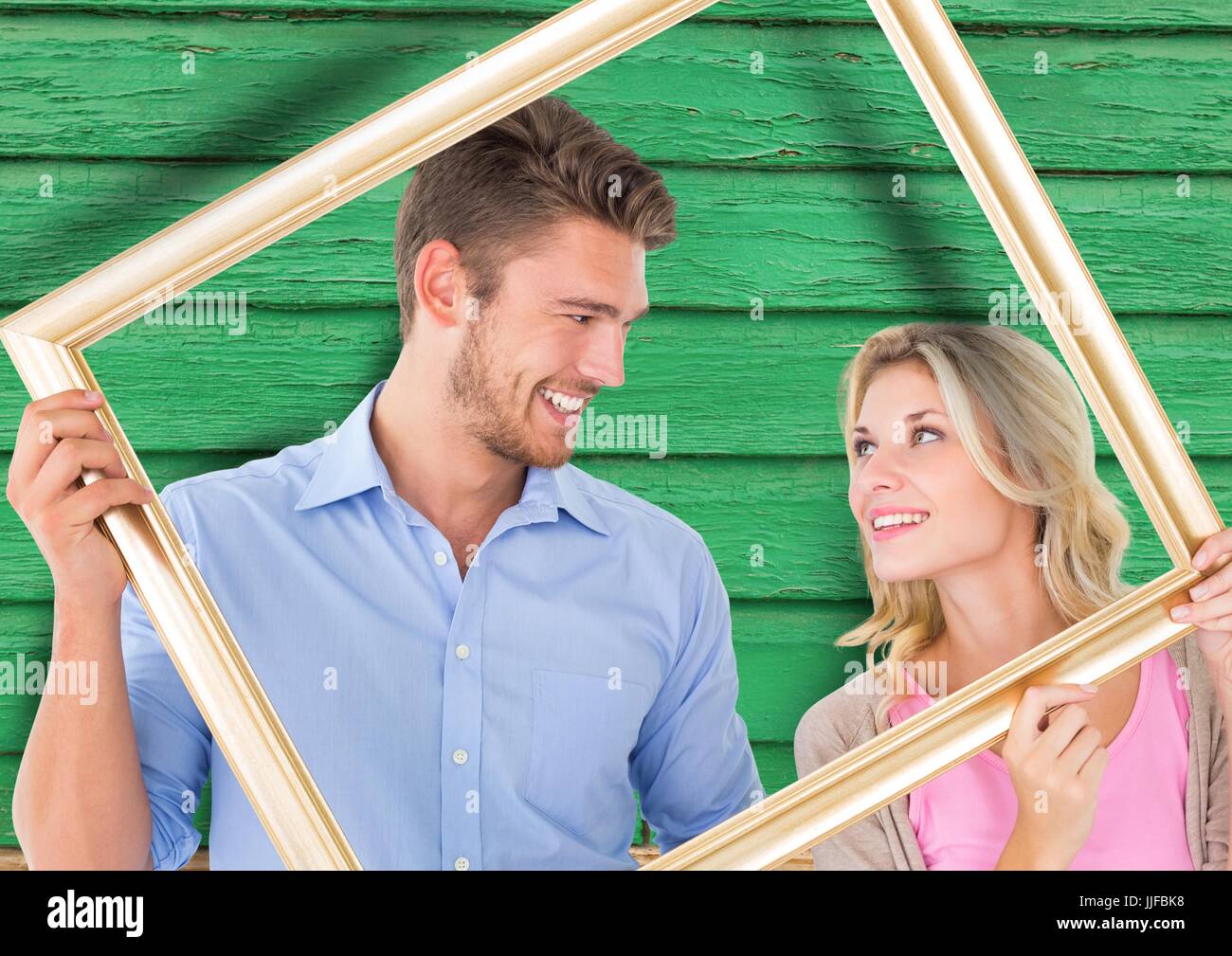 Digital composite of couple with frame with green wood background Stock ...