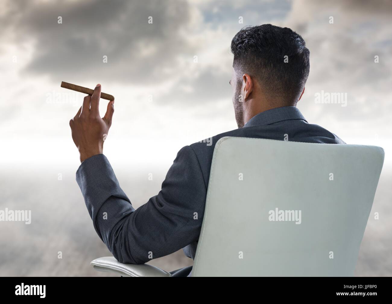 Digital composite of Back of seated business man smoking cigar and ...