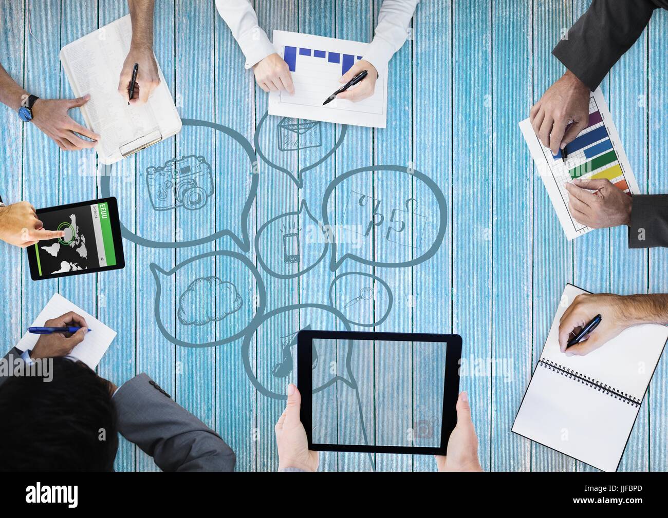 Digital composite of Overhead of hands writing with blue wood panel and ...