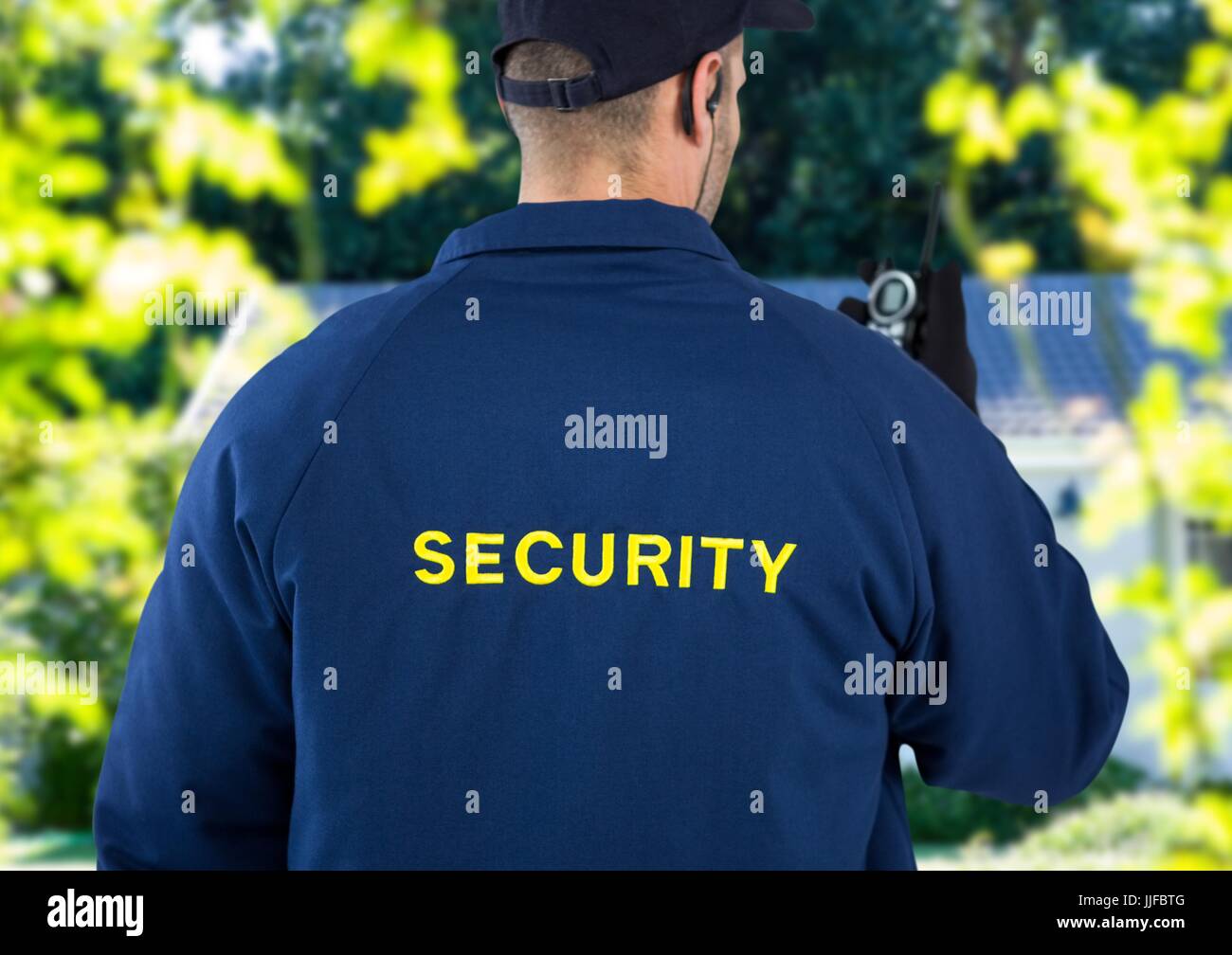Digital composite of security guard back in front of the house Stock ...
