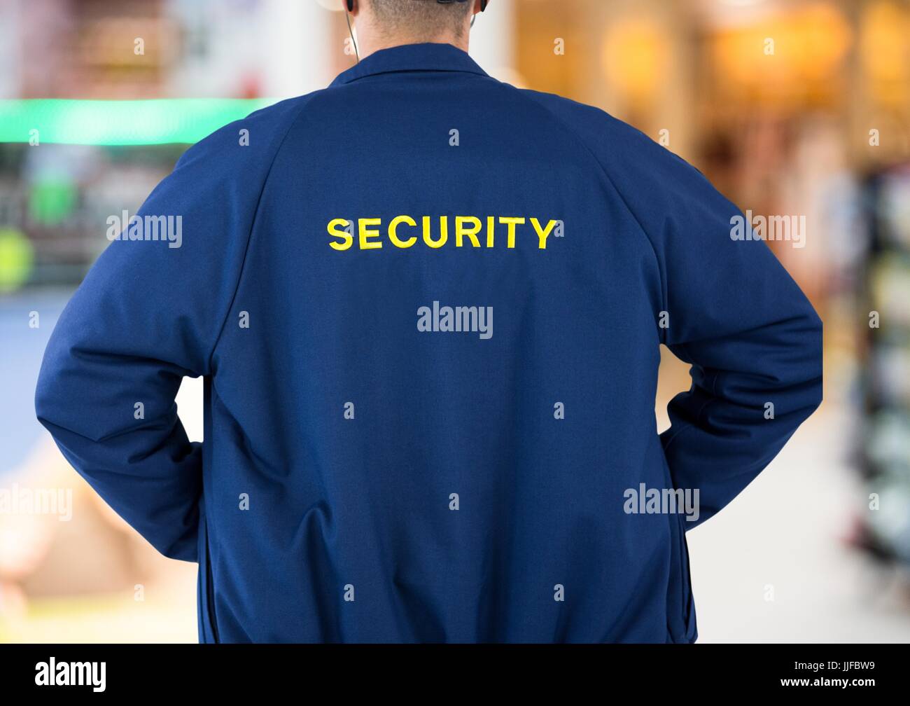 Digital composite of security guard back in lights background Stock ...