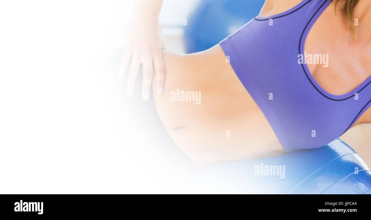 Digital composite of Woman mid section in sports bra with white ...