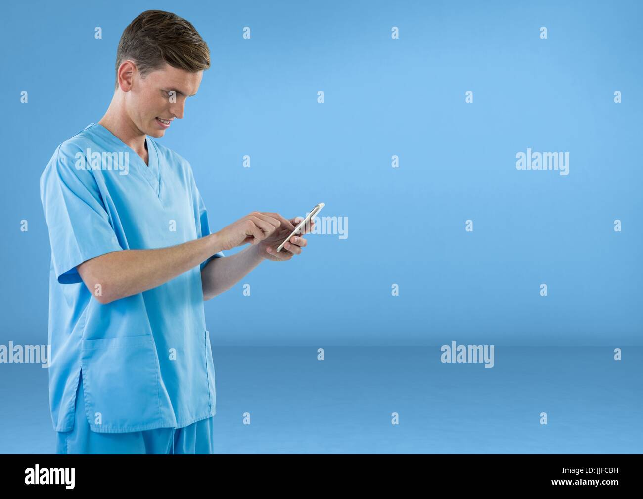 Digital composite of Doctor with a mobile phone against blue background ...