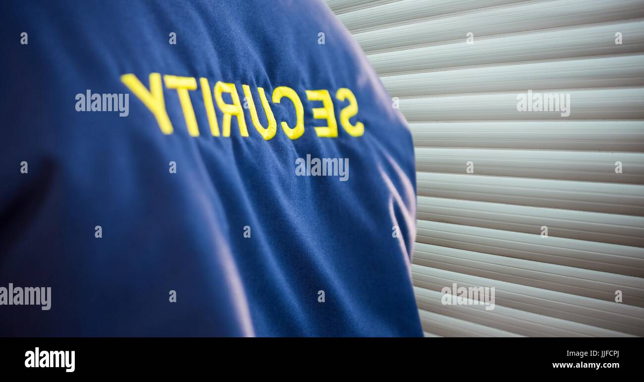 Digital composite of a focus on a security guard jacket near the blind ...